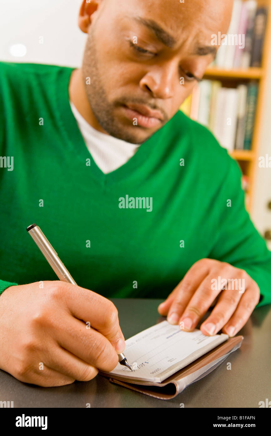 African man writing check Stock Photo - Alamy
