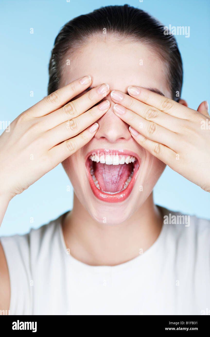 Young woman covering eyes Stock Photo - Alamy