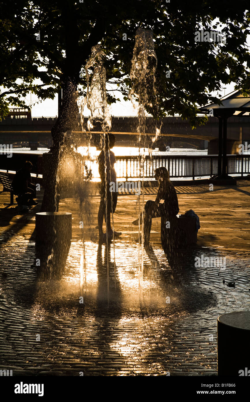 Young couple talking by a fountain Stock Photo - Alamy