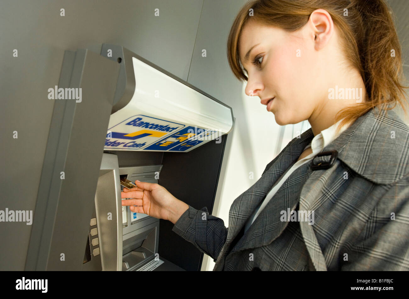 Side profile of a businesswoman using an ATM Stock Photo - Alamy