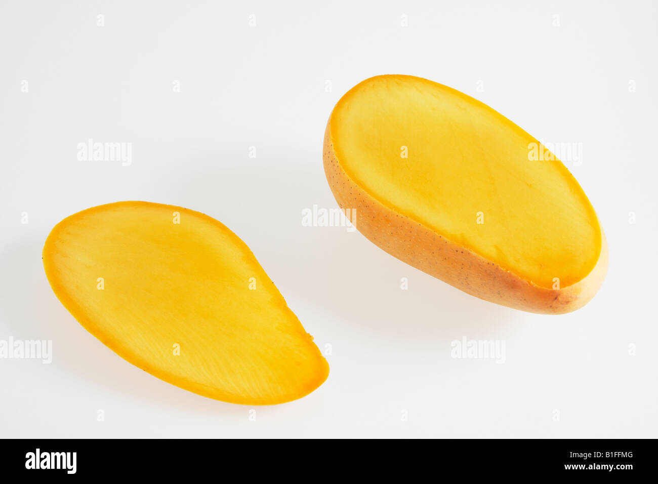 Cut Open Halves Of Mango On White Background In Studio Stock Photo - Alamy