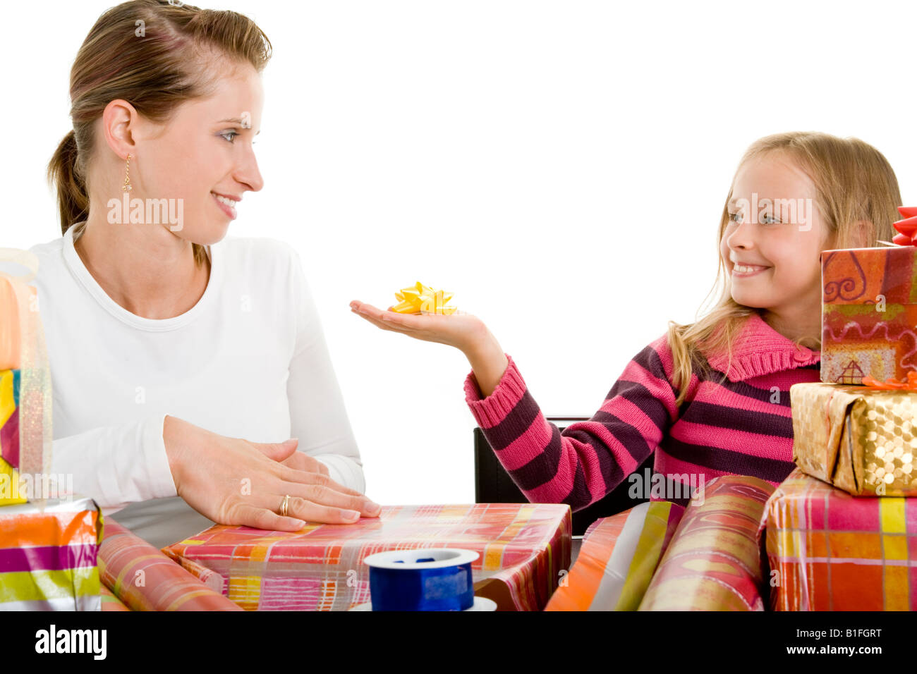 young girl and her mother are packing gifts Stock Photo - Alamy