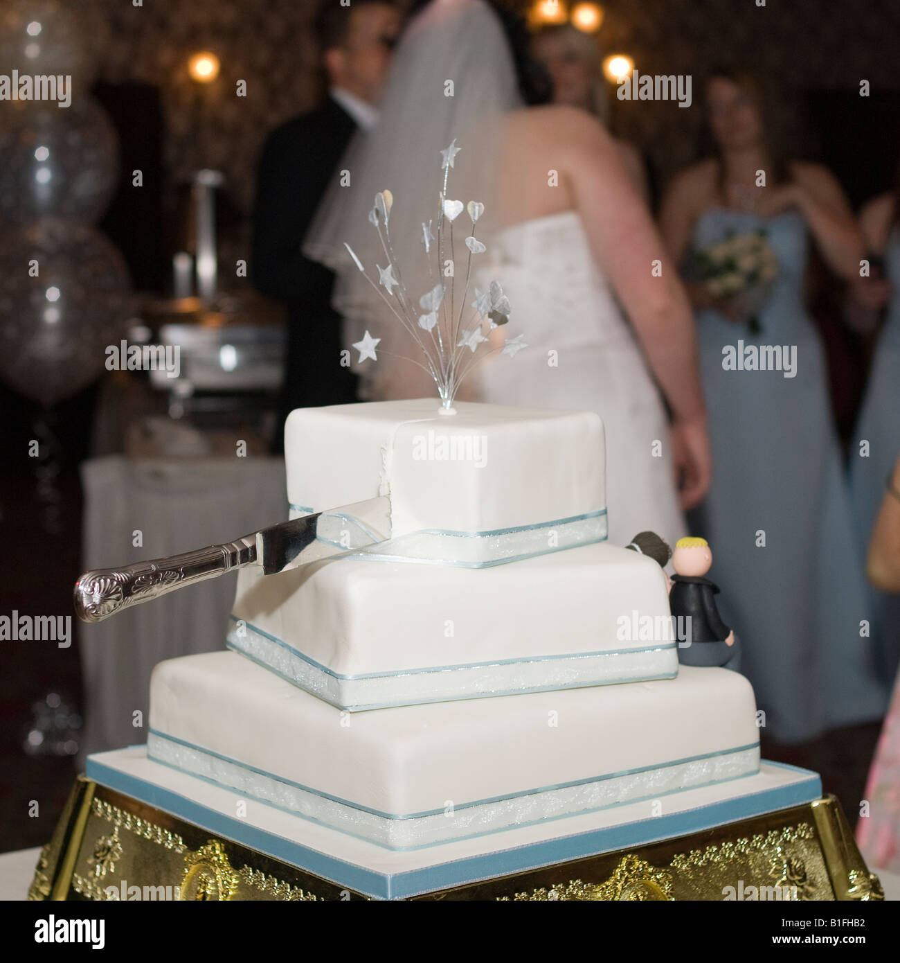 A wedding cake stabbed by the bride and groom Stock Photo - Alamy