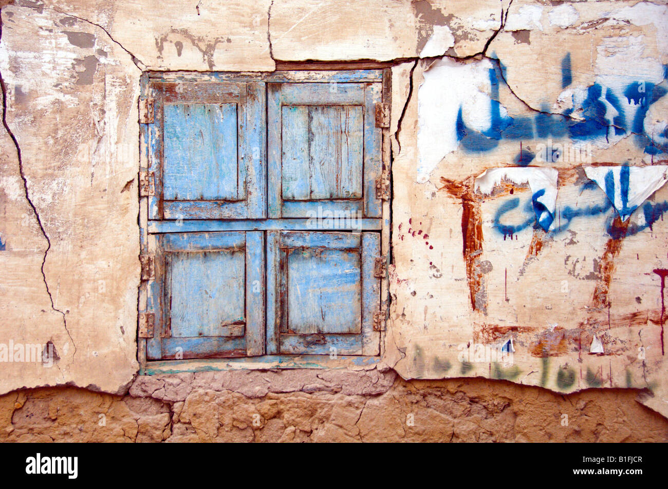 A blue door and graffiti in the desert oasis village of Bawiti Egypt ...