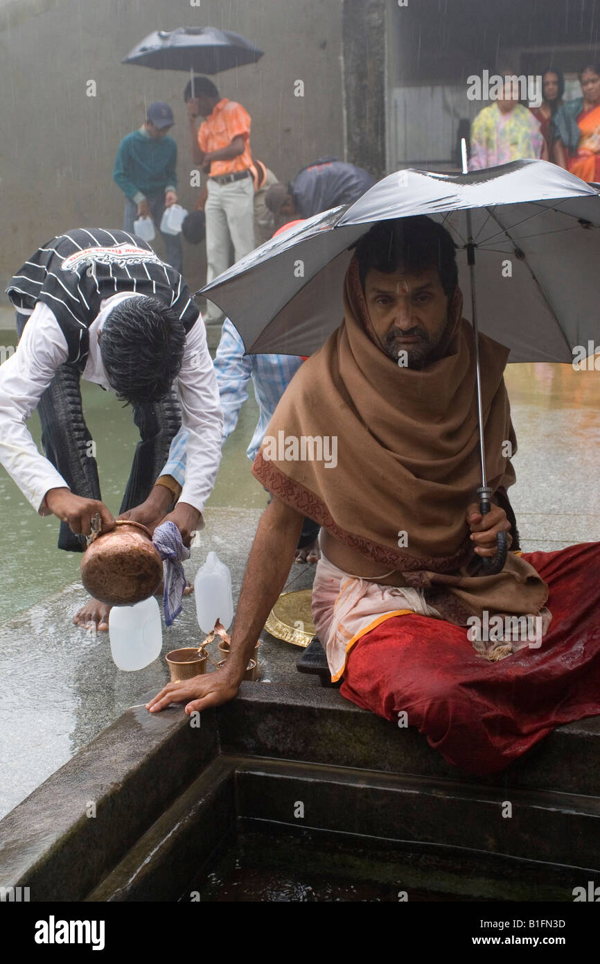 The priest or pujari sits at the wet Sri Agasteshwara Temple in the ...