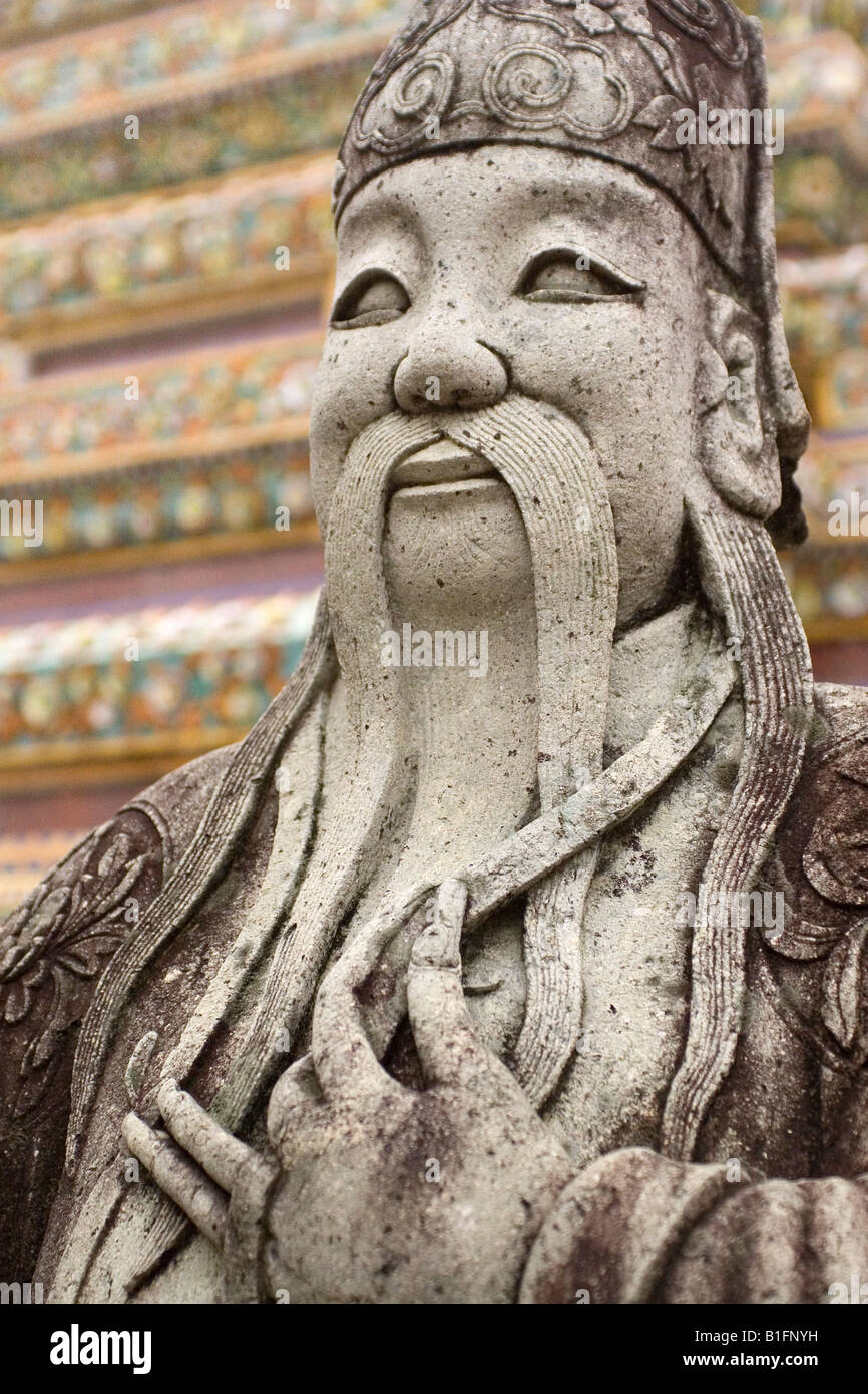 A statue of a mandarin in the courtyard of the Wat Pho Temple in ...