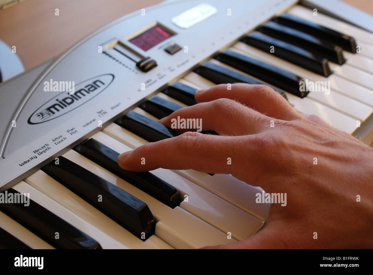 Hand playing keyboard Stock Photo - Alamy