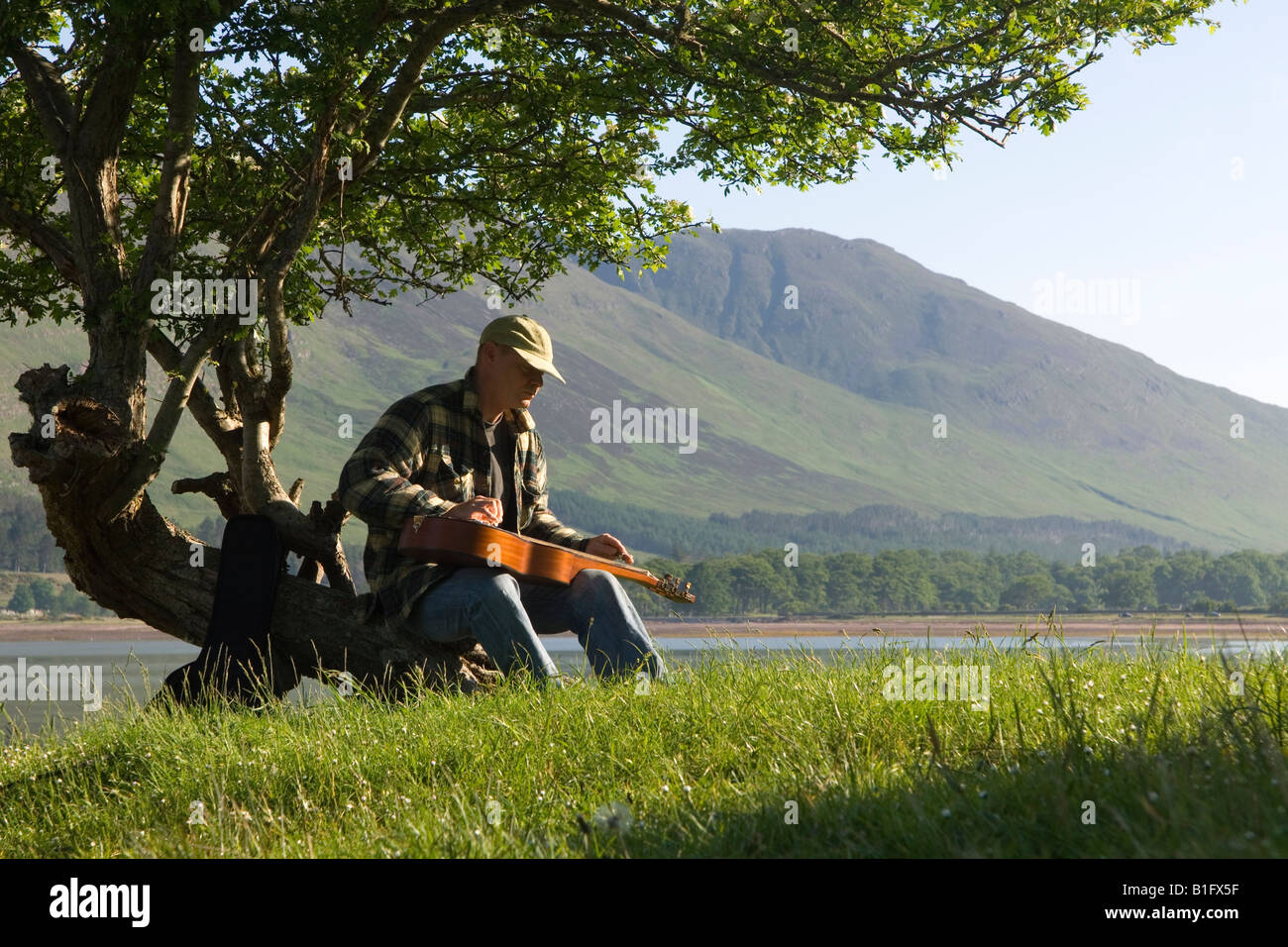 Robin Clark owner of Busker Guitars plays one of Busker guitars ...