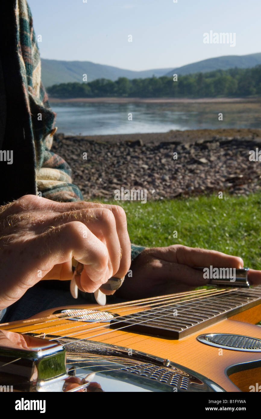 Robin Clark owner of Busker Guitars plays one of Busker guitars ...