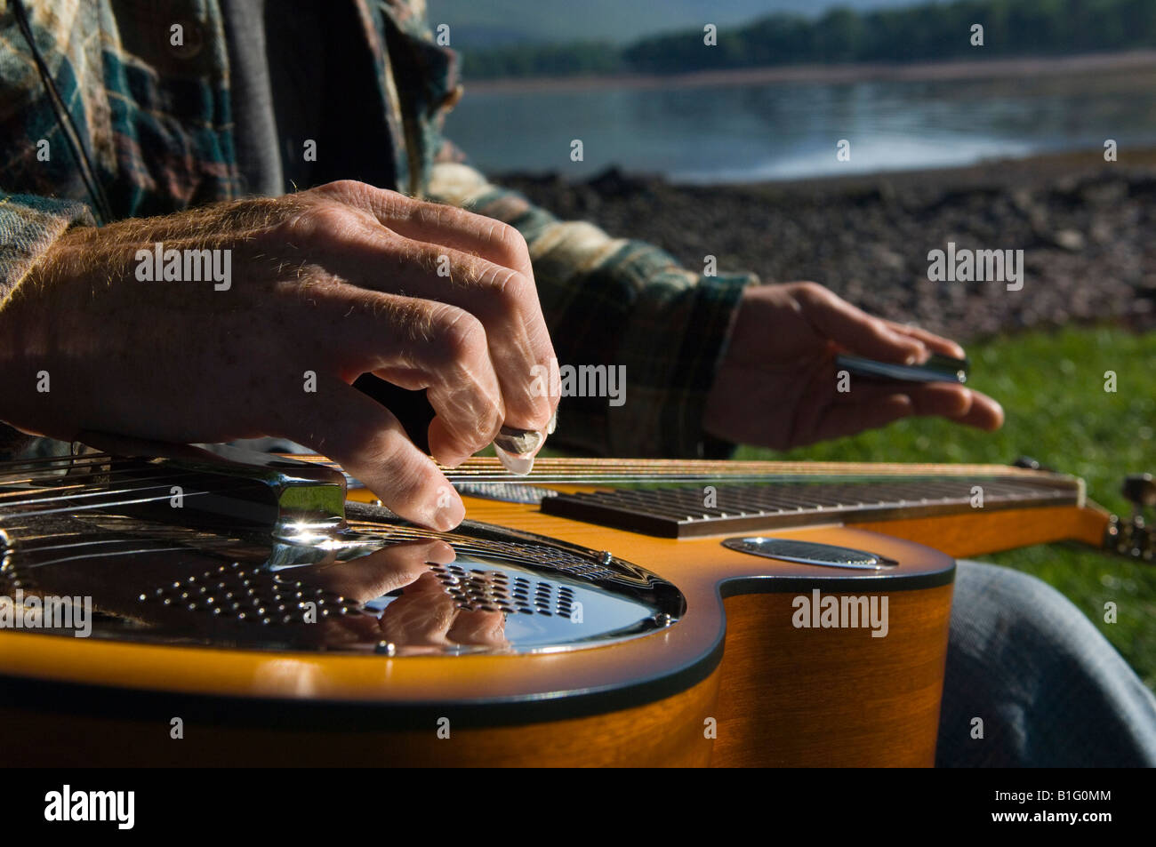 Robin Clark owner of Busker Guitars plays one of Busker guitars ...