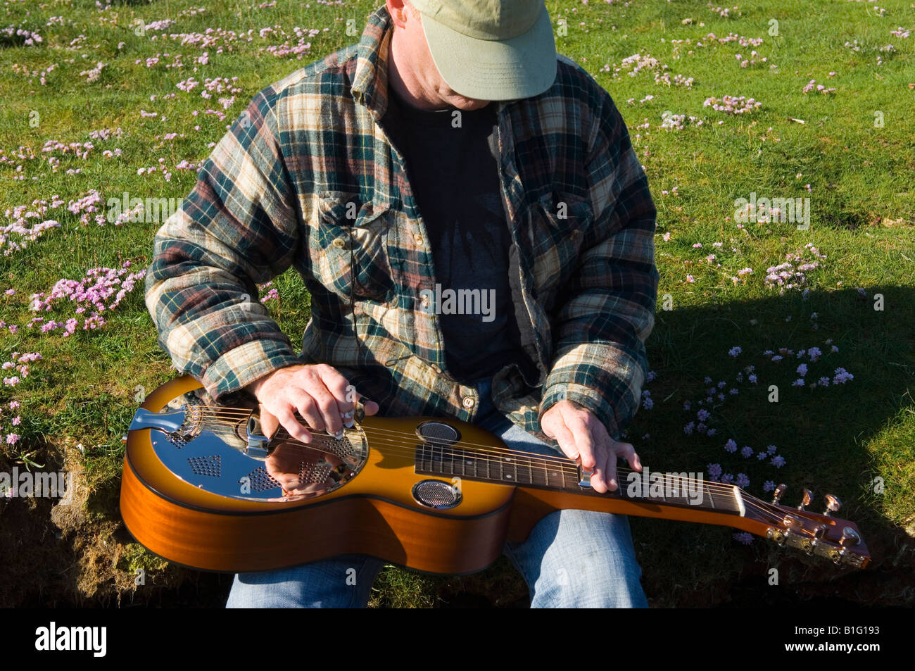 Robin Clark owner of Busker Guitars plays one of Busker guitars ...