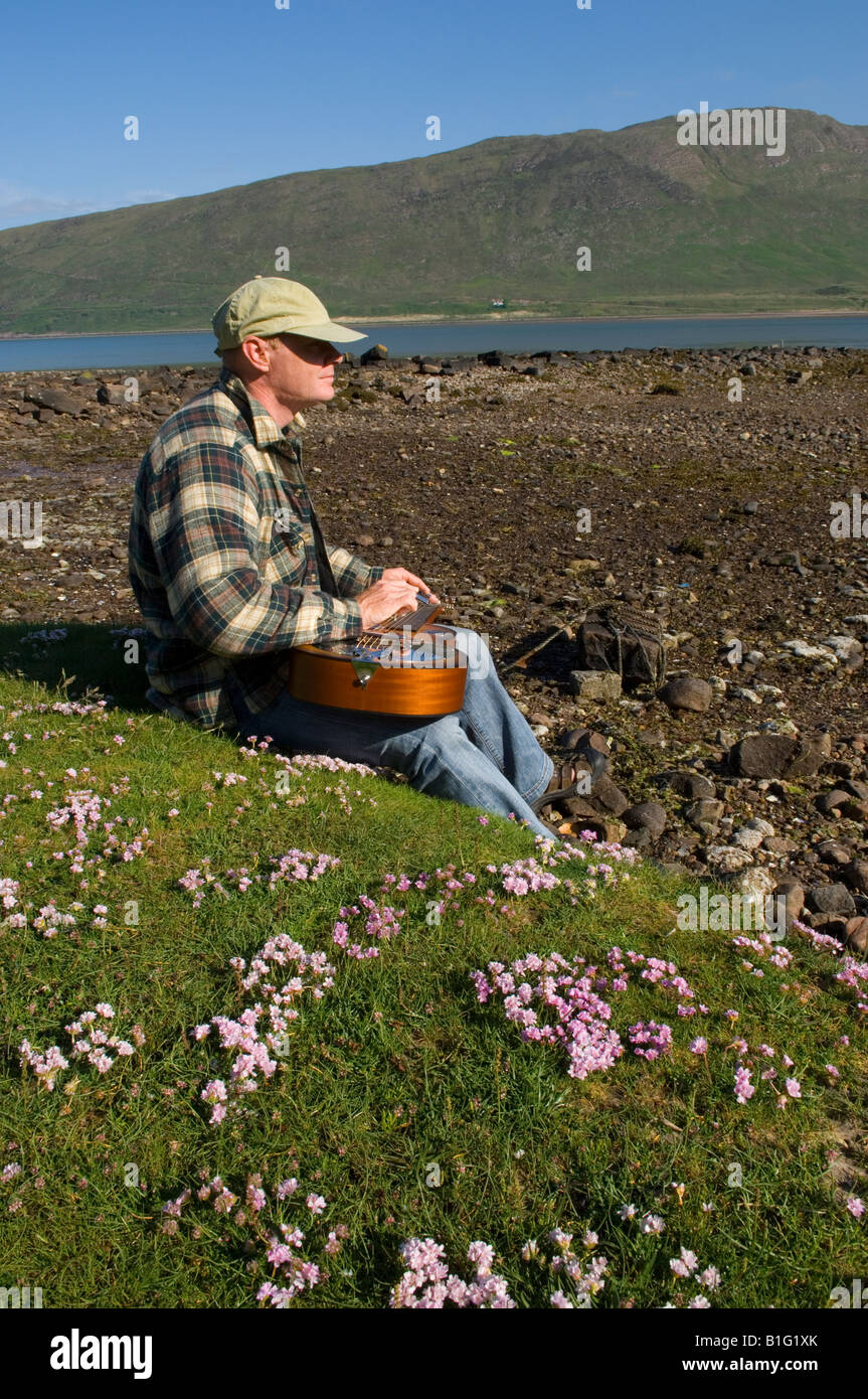 Robin Clark owner of Busker Guitars plays one of Busker guitars ...