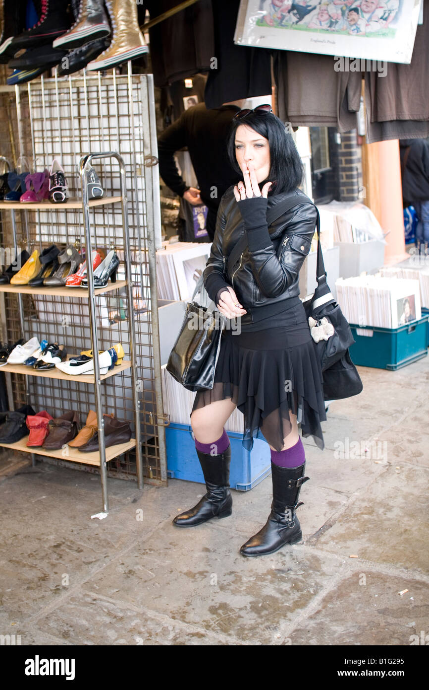 A female goth smokes a cigarette at London's Camden market Stock Photo ...