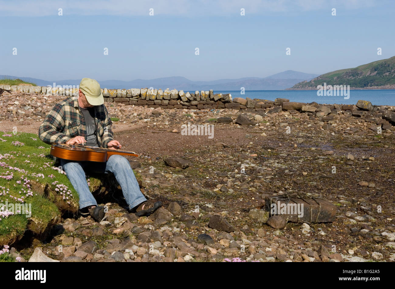 Robin Clark owner of Busker Guitars plays one of Busker guitars ...