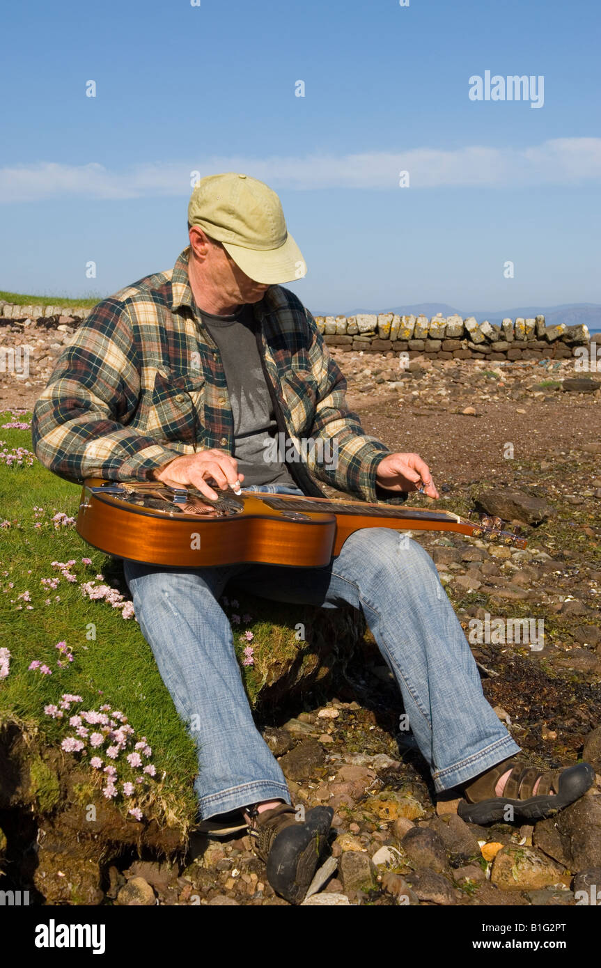 Robin Clark owner of Busker Guitars plays one of Busker guitars ...