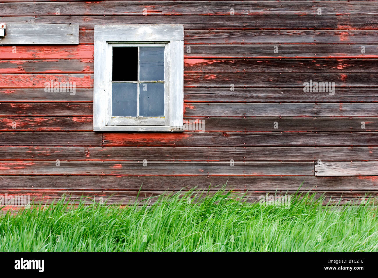 Broken window on side of red barn Stock Photo - Alamy