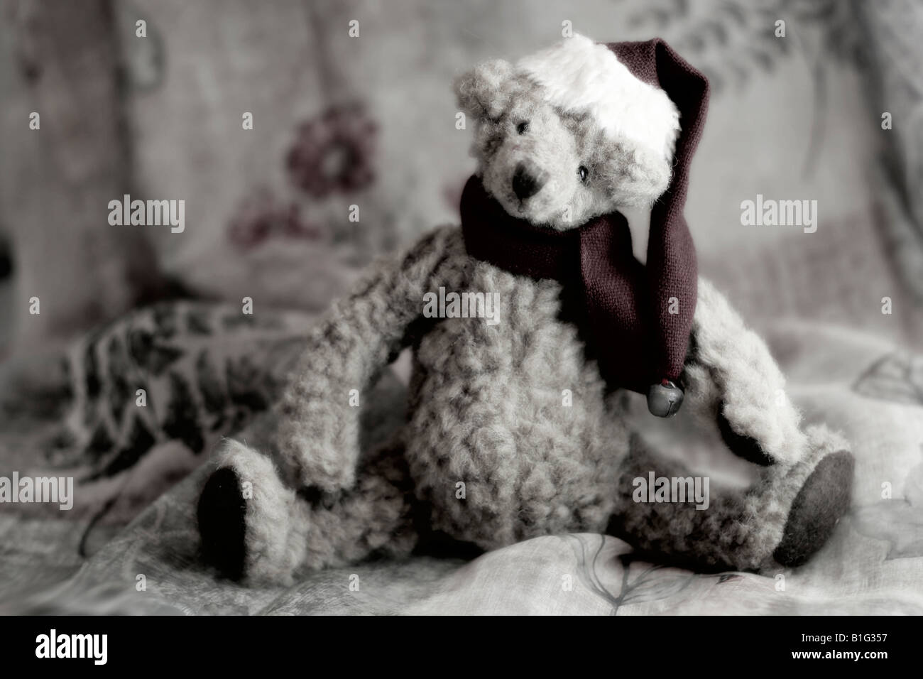 Stuffed teddy bear wearing red Santa hat and scarf Stock Photo - Alamy