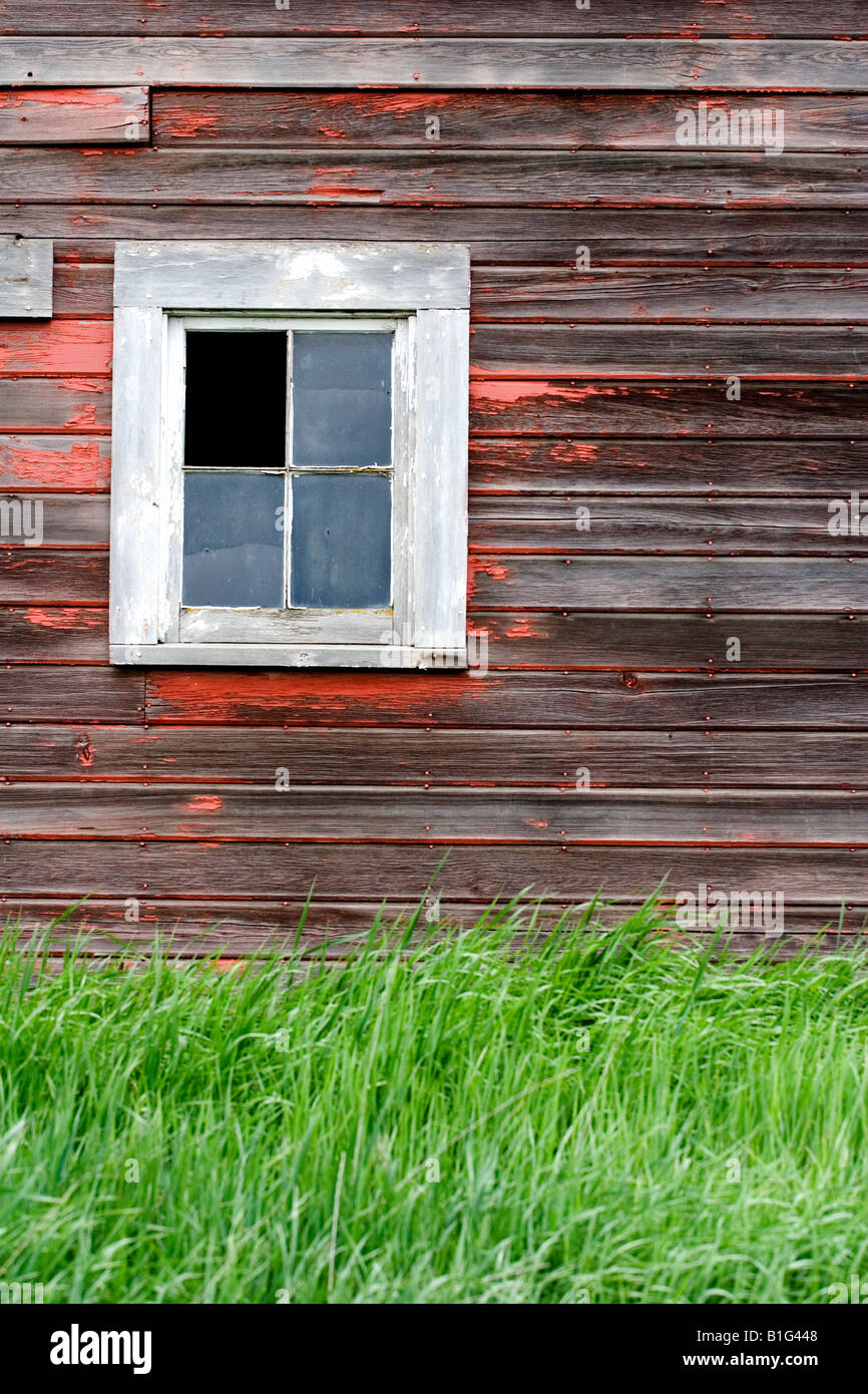 Broken window on side of red barn Stock Photo - Alamy