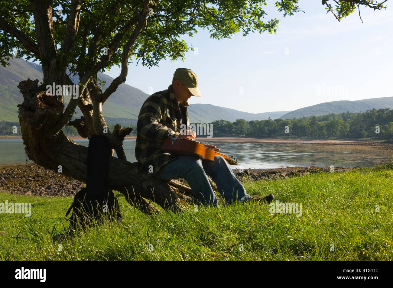 Robin Clark owner of Busker Guitars plays one of Busker guitars ...