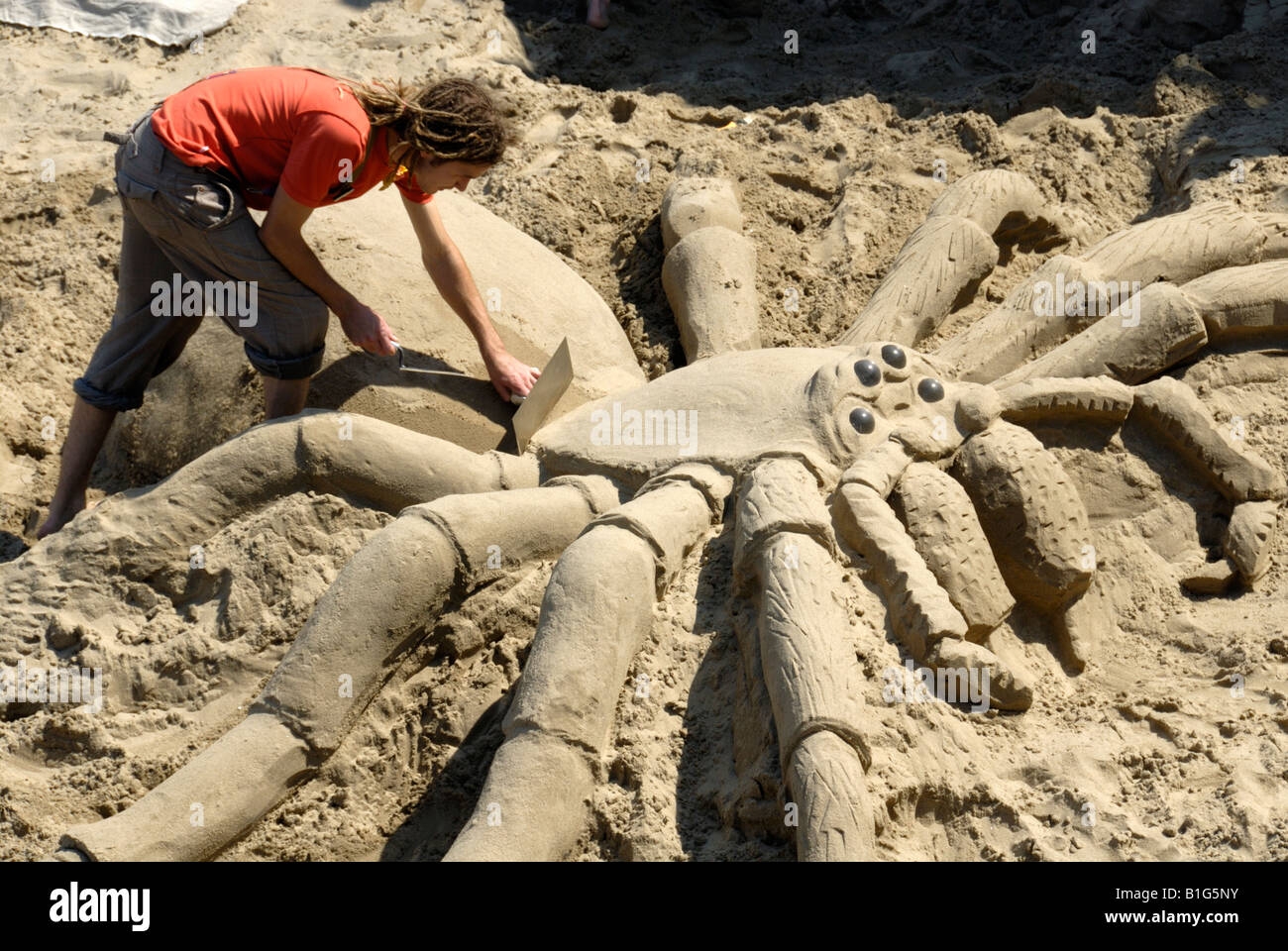 Man making sand sculpture on Thames beach, London Stock Photo - Alamy
