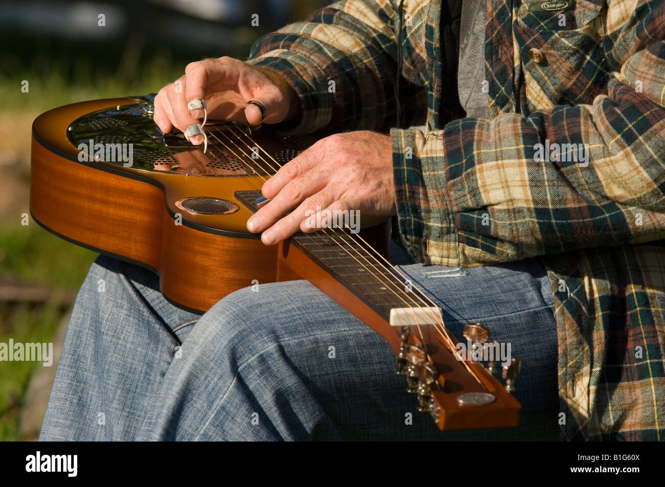 Robin Clark owner of Busker Guitars plays one of Busker guitars ...