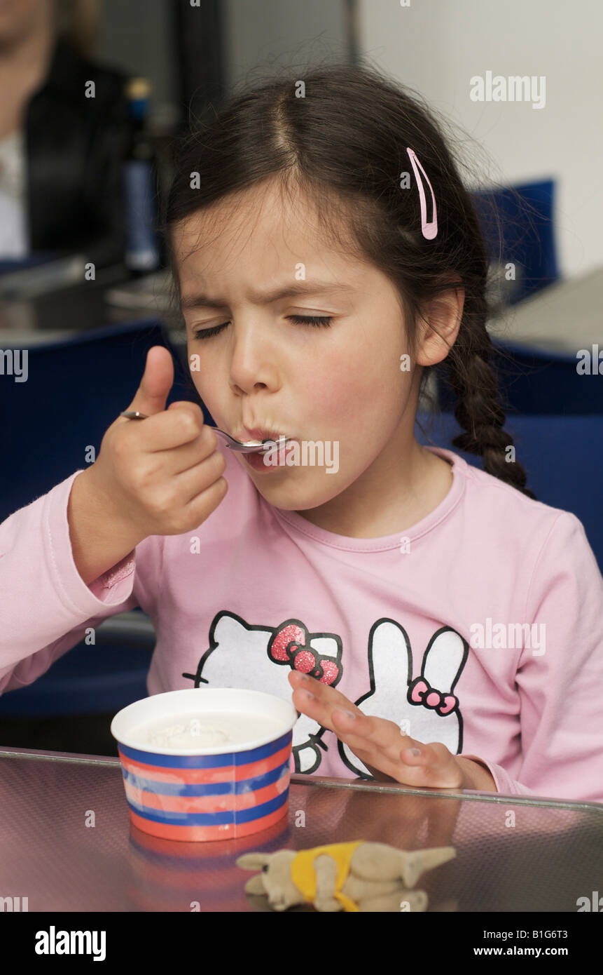 Child six years of age enjoys ice cream in outdoors cafe Stock Photo ...