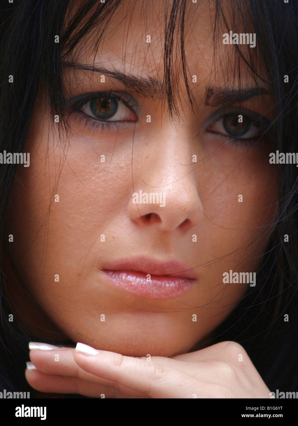 Detail of a sad woman looking at camera Stock Photo - Alamy