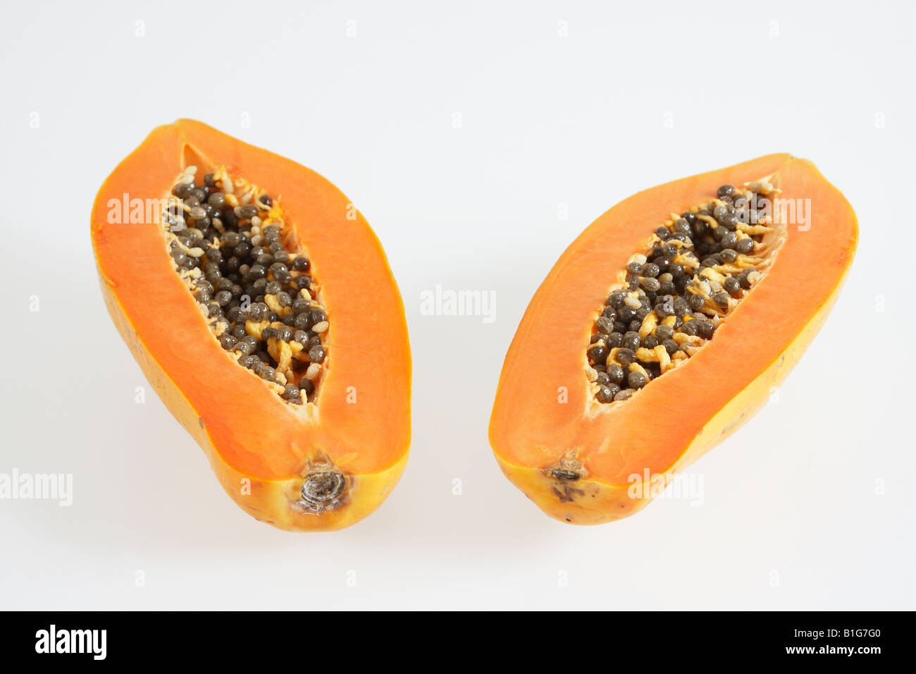 Cut Open Halves Of Papaya On White Background In Studio Stock Photo - Alamy