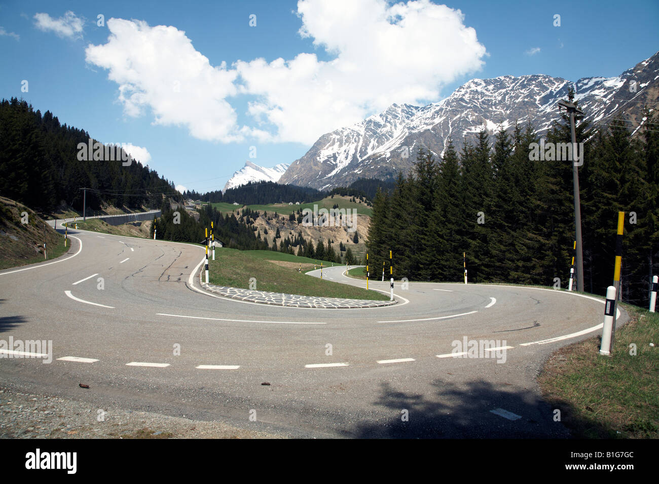 bend in road in the swiss alps during the summer season Stock Photo - Alamy