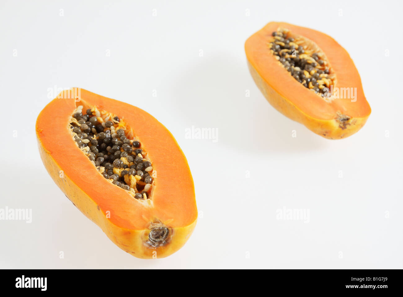 Cut Open Halves Of Papaya On White Background In Studio Stock Photo - Alamy