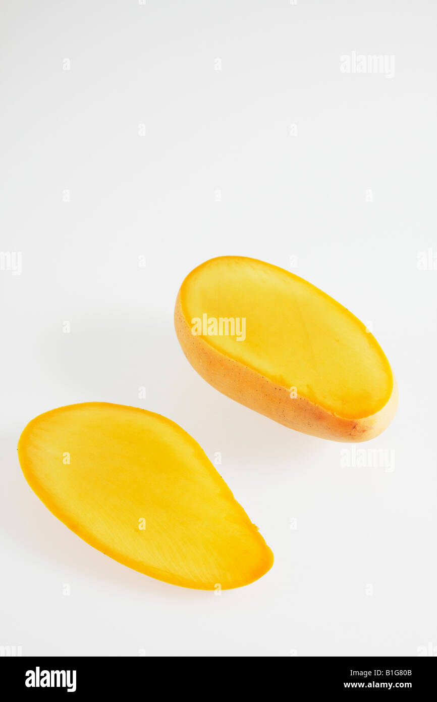 Cut Open Halves Of Mango On White Background In Studio Stock Photo - Alamy