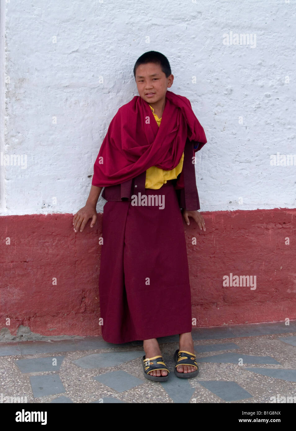 monk resting against a wall at the Phodong Monastery in Sikkim Stock ...