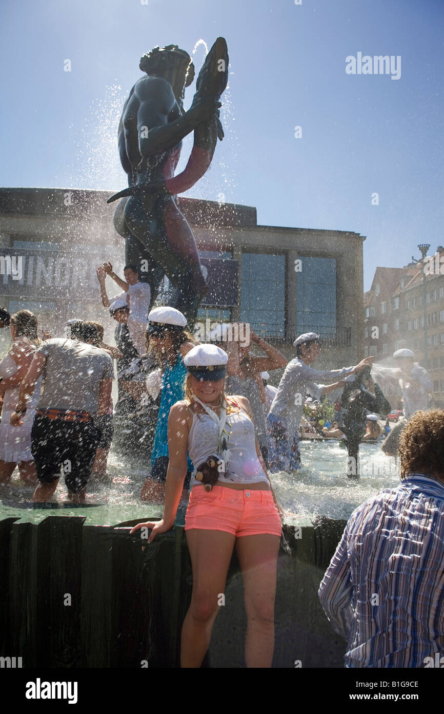 High school students take refreshing splash in the fountain under ...