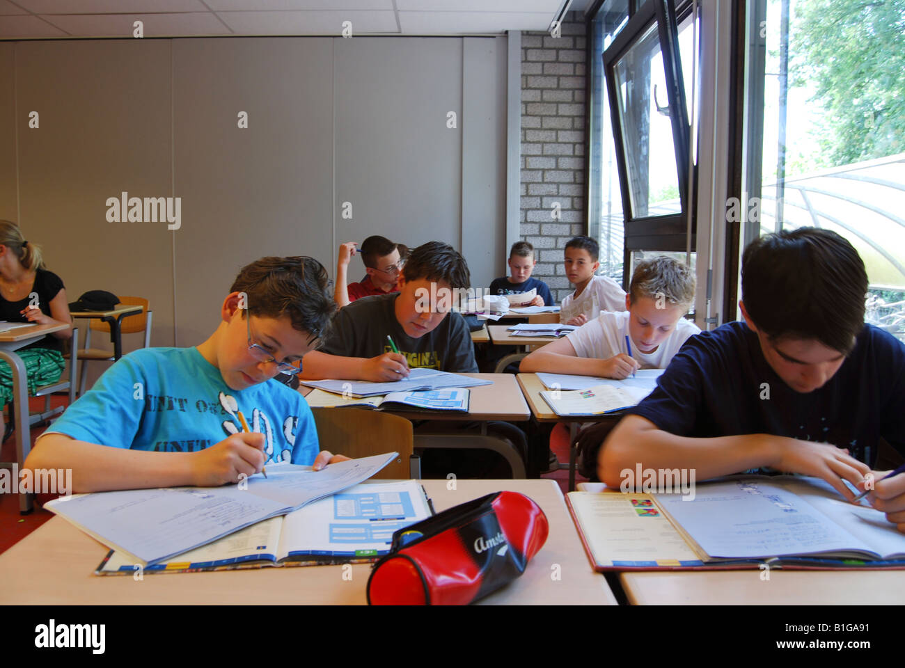 schoolboys in class working Stock Photo - Alamy
