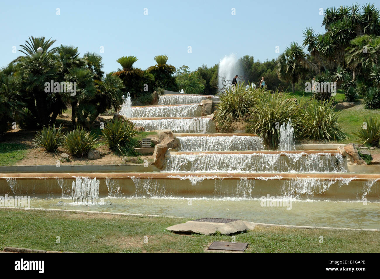Cascading waterfalls enhanced by the blue sky in Montjuic Park ...