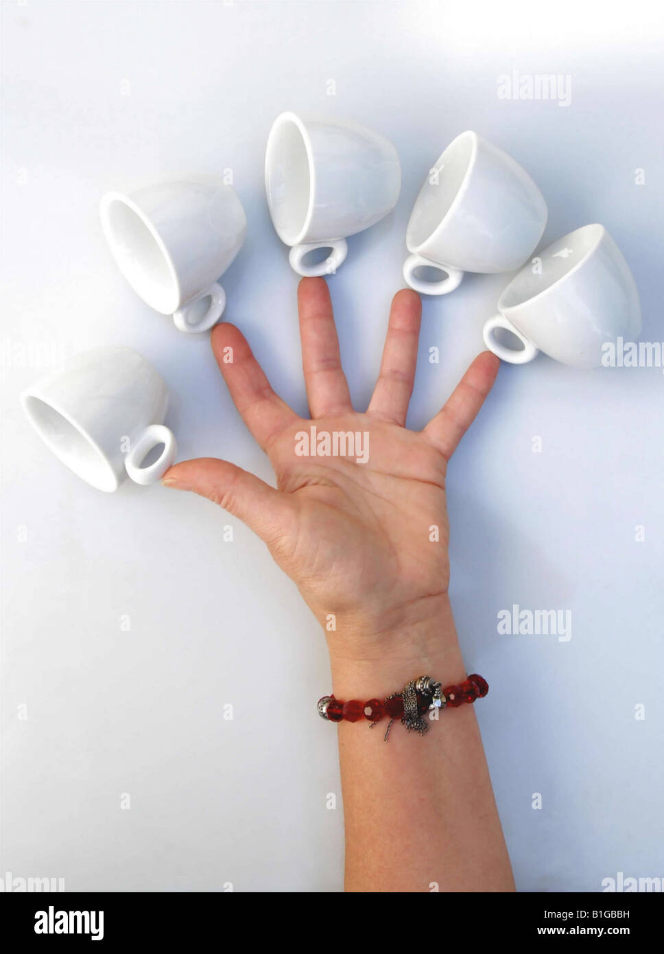 Studio shot of a open hand with cups Stock Photo - Alamy