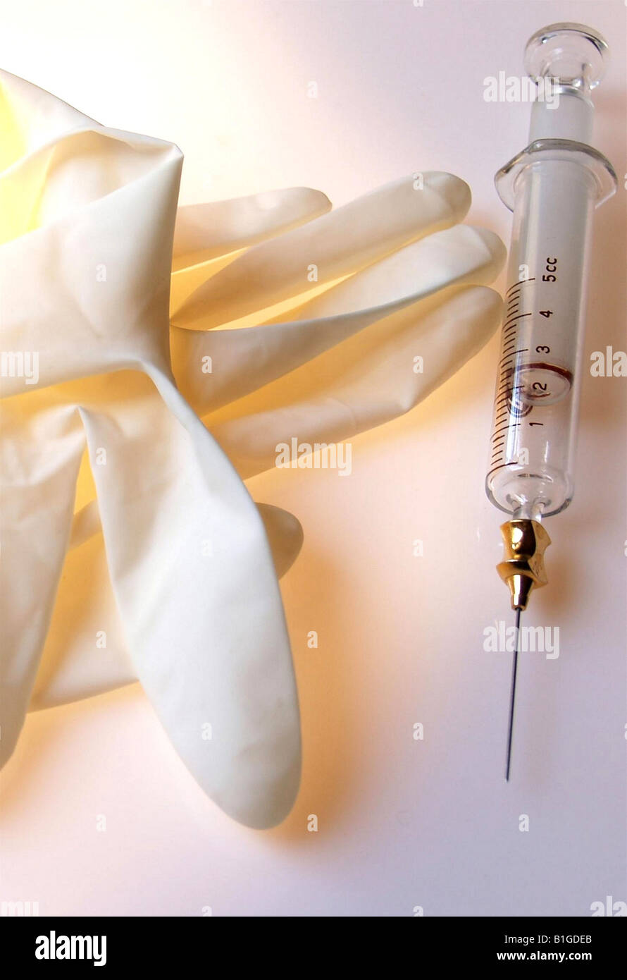 Studio shot of surgical gloves and syringe Stock Photo - Alamy