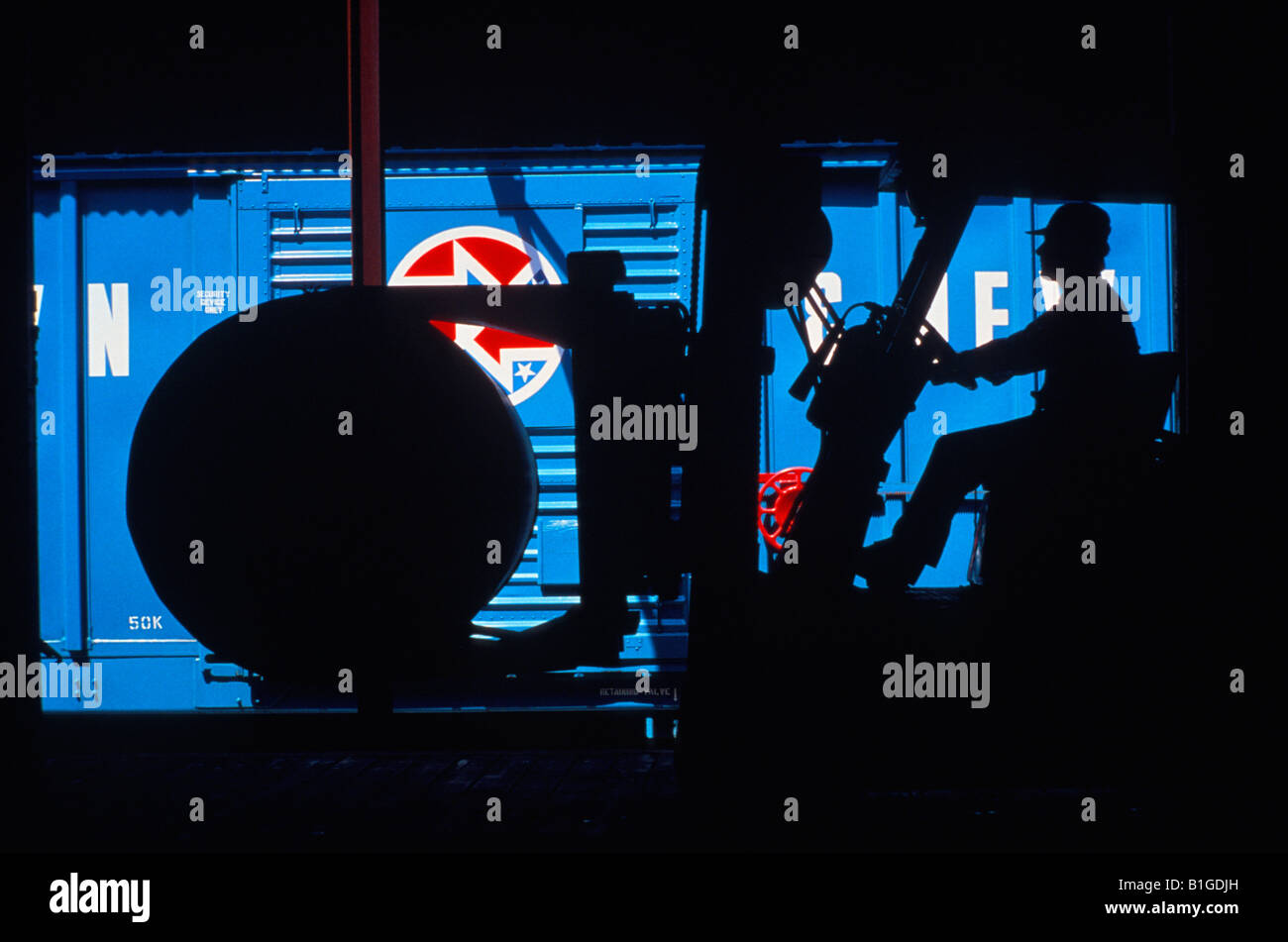 Forklift loading paper roll into boxcar Stock Photo - Alamy