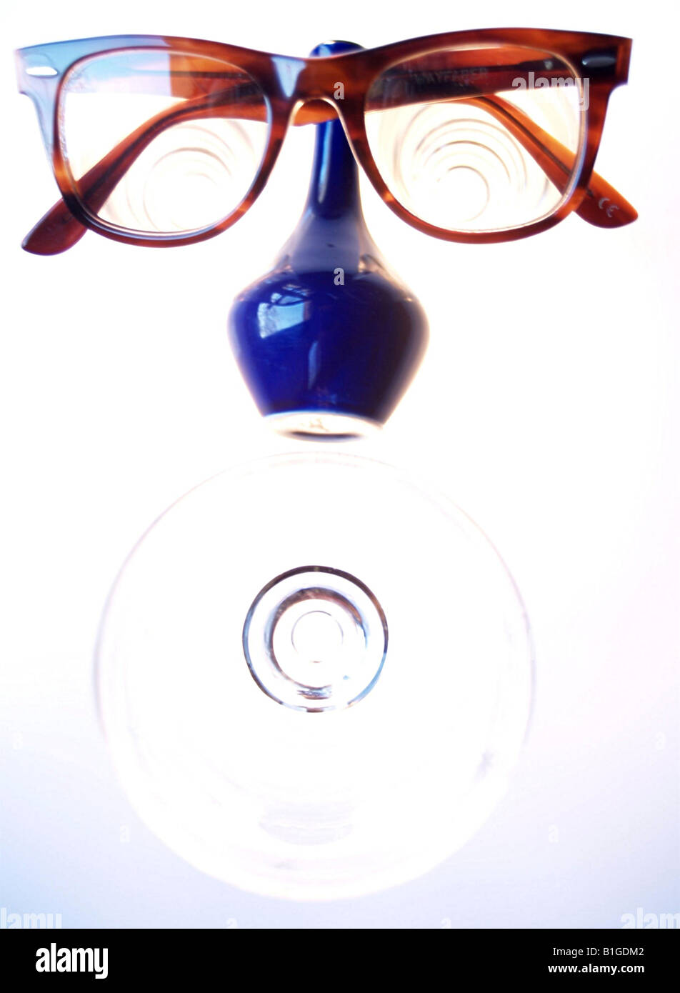 Overhead view of glasses and object in shape of face Stock Photo - Alamy