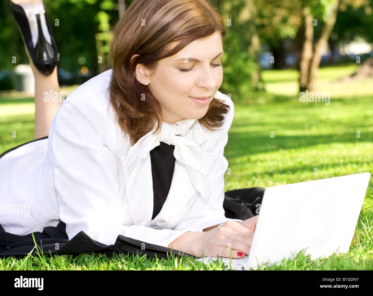 picture of office lady with laptop computer laying on the grass Stock ...