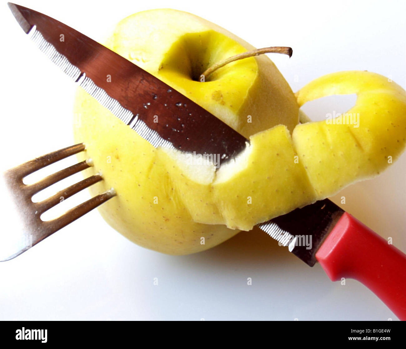 Detail of apple with knife and fork Stock Photo - Alamy