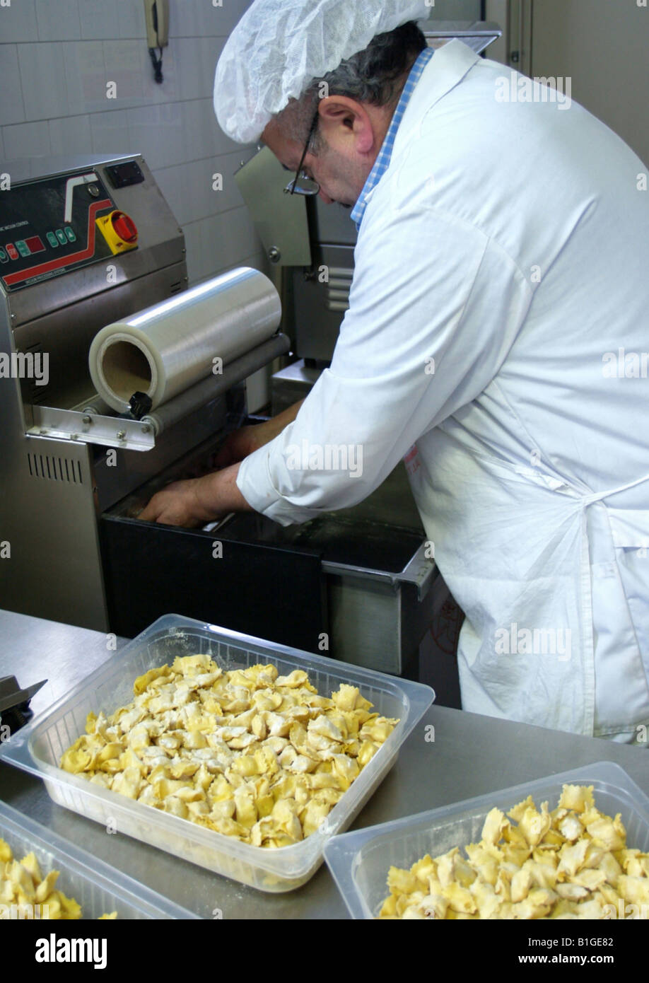 Side view of a man working in food factory Stock Photo - Alamy