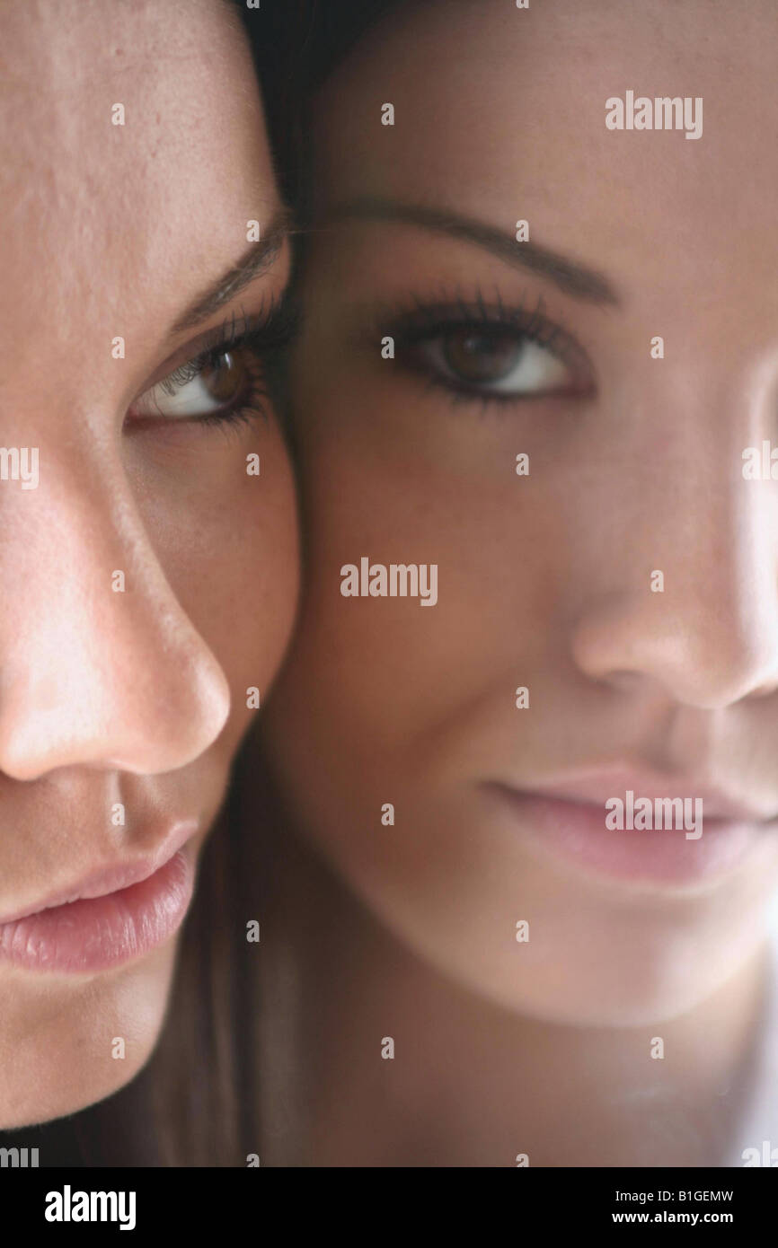 Detail of a young woman looking her reflection in mirror Stock Photo ...