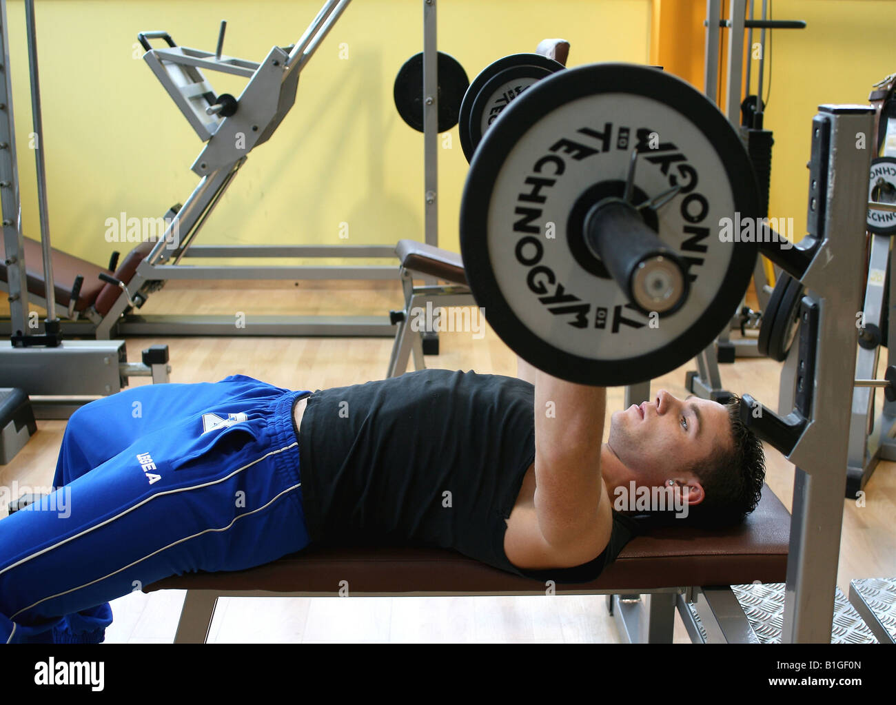 Side view of a man weightlifting in gym Stock Photo - Alamy