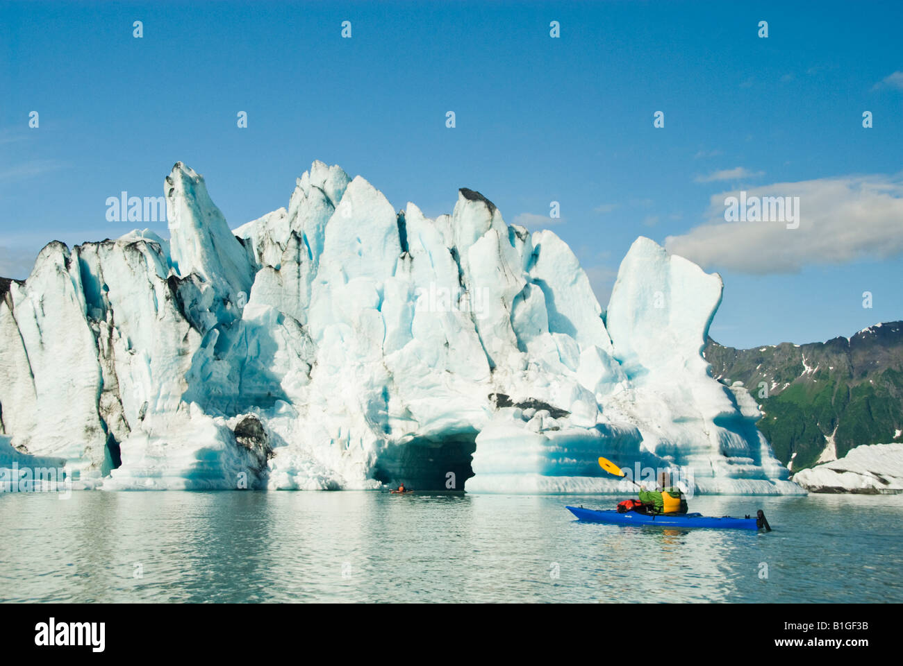 Kayakers check out a 'kryptonite' iceberg on Bear Lake Kenai Fjords ...