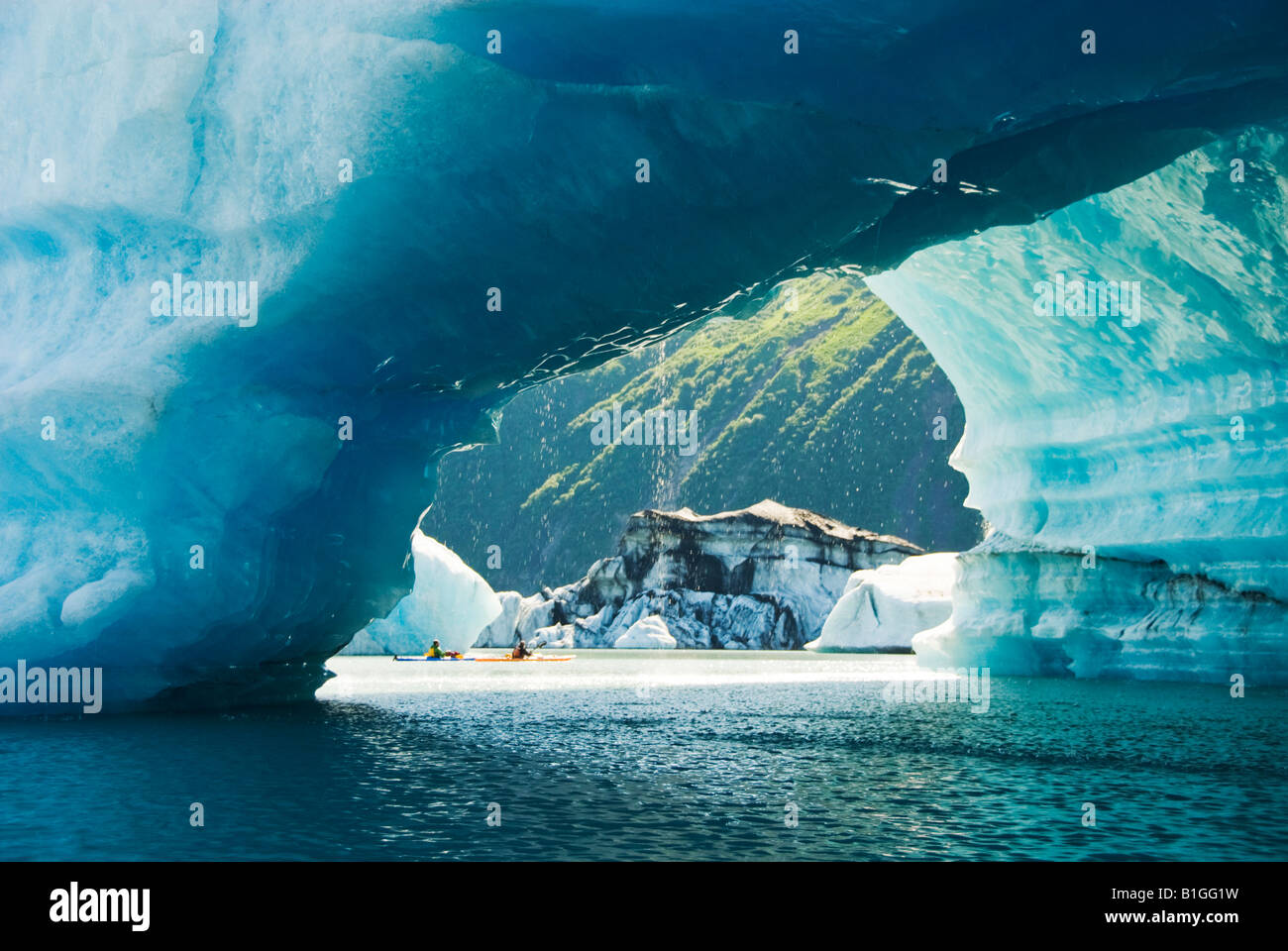 Kayakers check out a natural ice bridge on Bear Lake Kenai Fjords ...