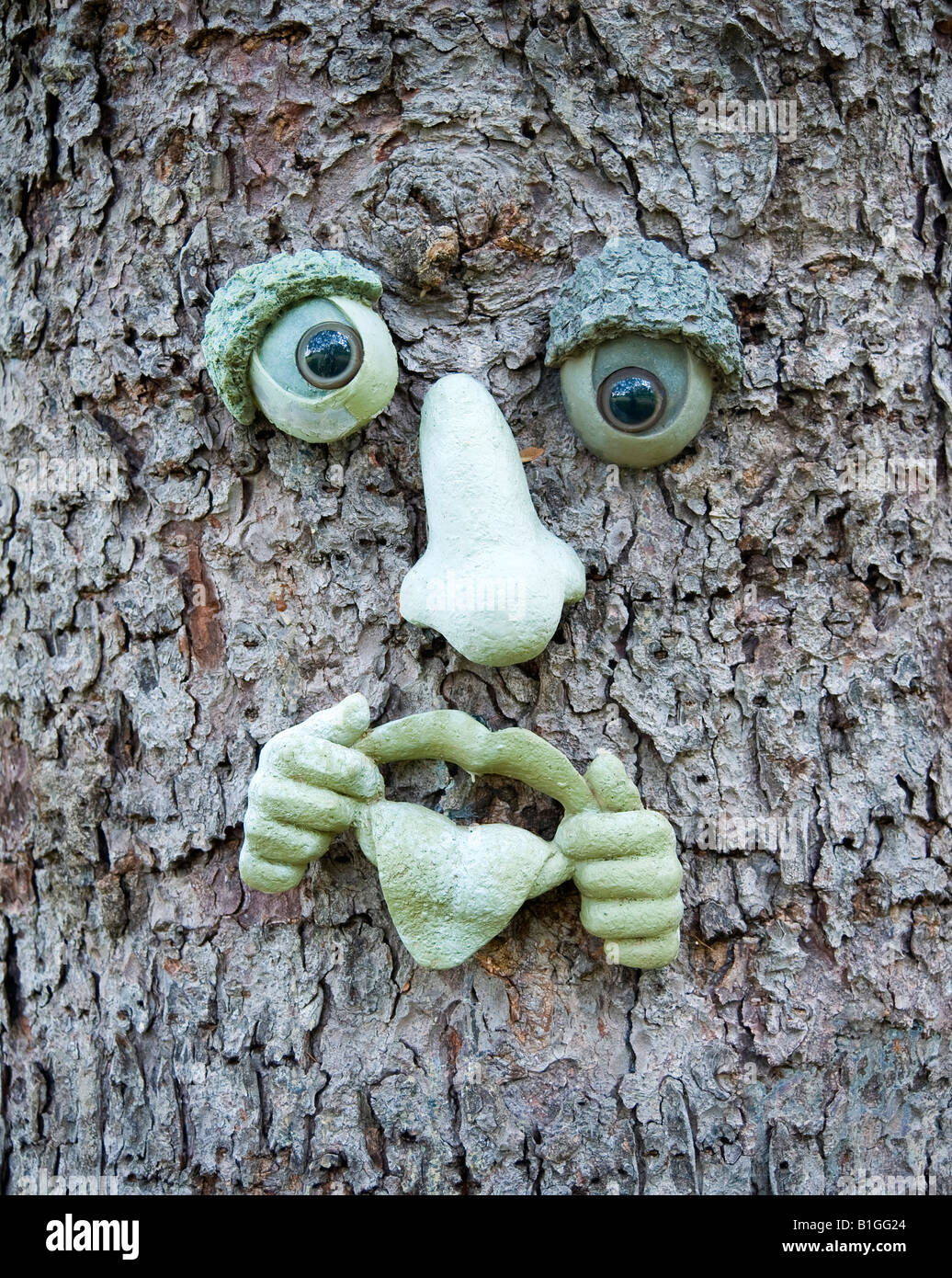 artistic ceramic face parts on pine tree bark Stock Photo - Alamy