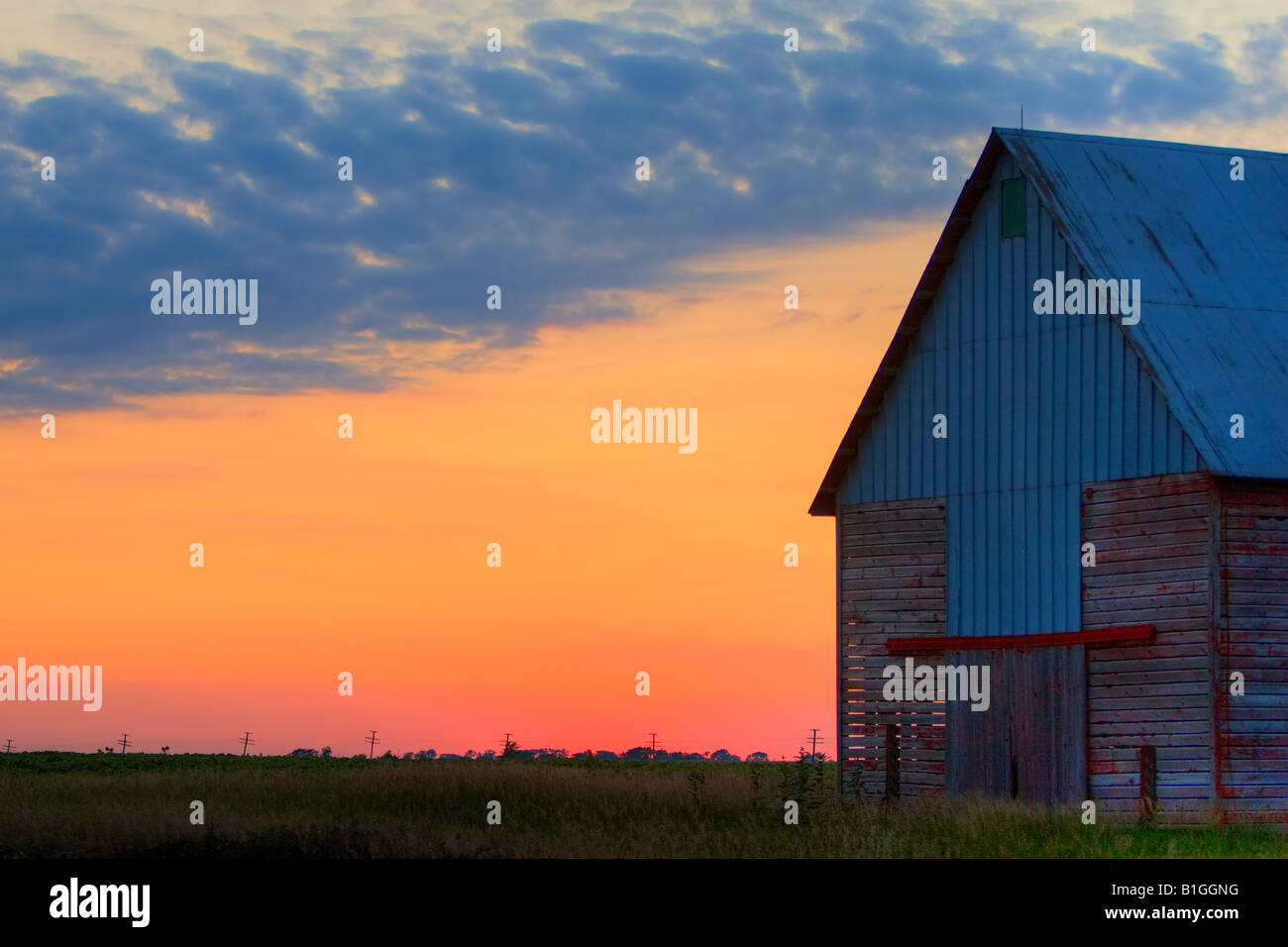 A barn in a field in rural Illinois shortly after sunset. This is an ...