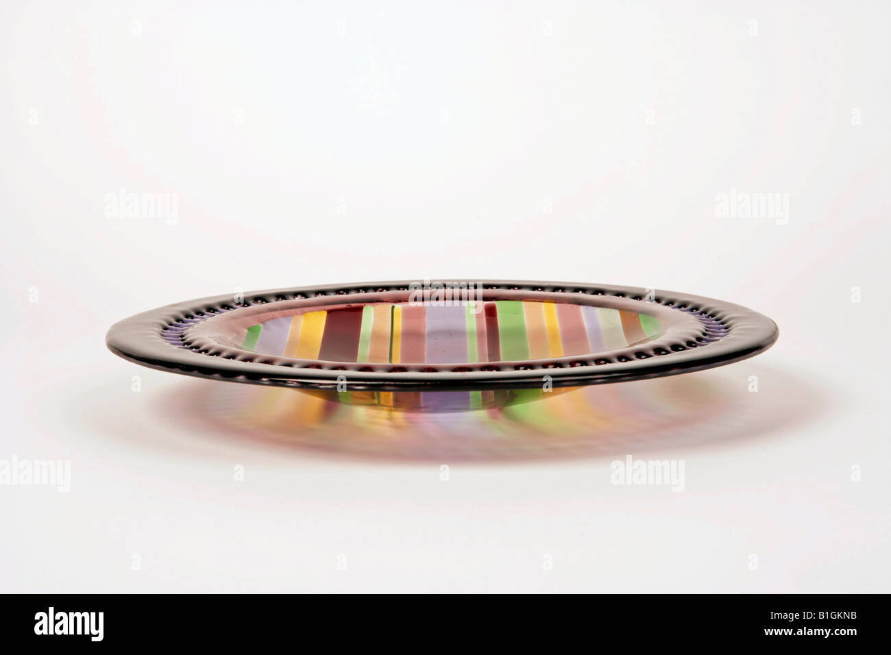 glass plate with light shining through onto the surface below rainbow ...