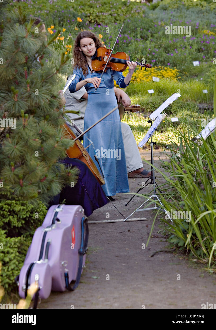 Young lady playing violin at the Botanical Garden in Riga Latvia Stock ...